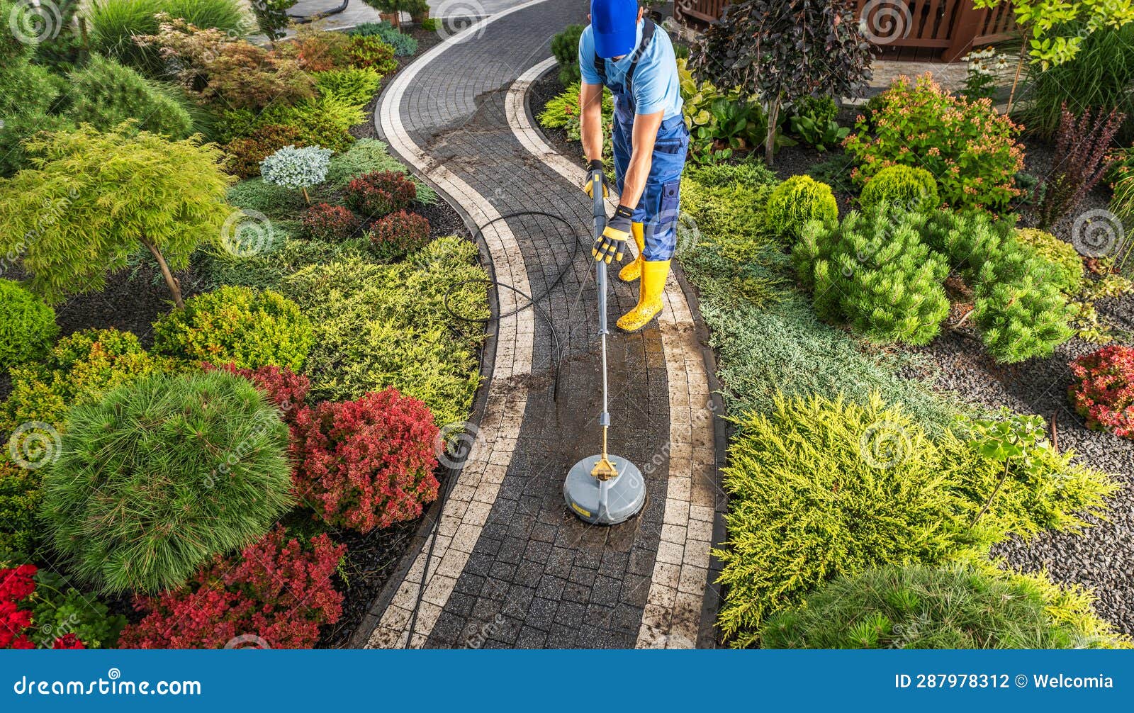 Back Yard Garden Pathways Washing Performed by Professional Worker ...