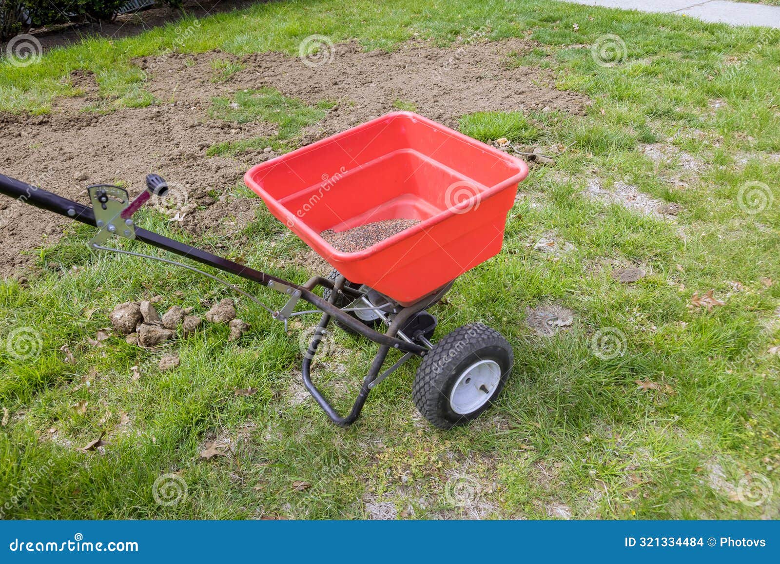 In Back Yard of Residential Property, Lawn Grass Seeds are Sown Using a ...