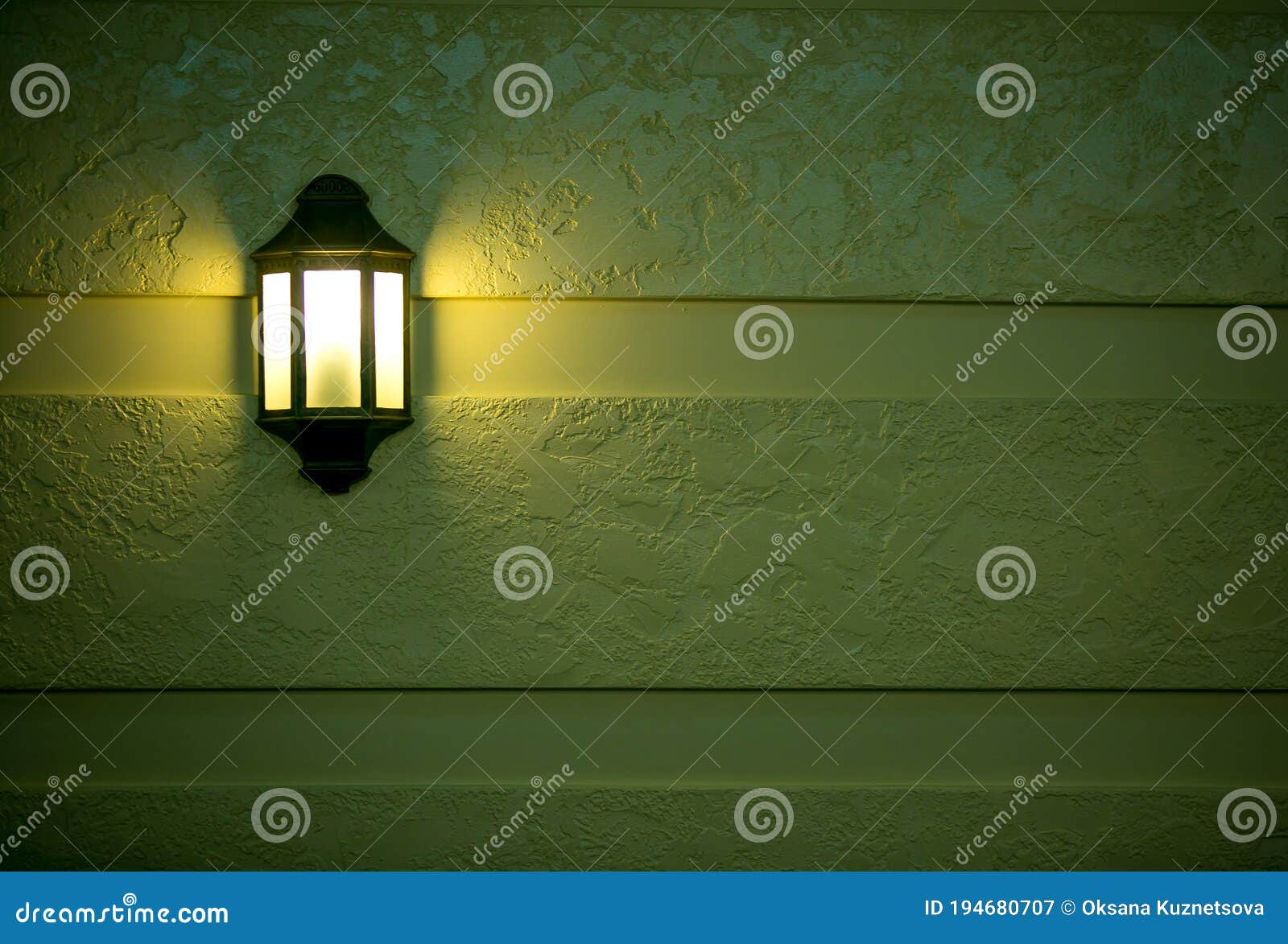 Background. Burning Lamp of a Geometric Shape on a Green Wall Stock ...