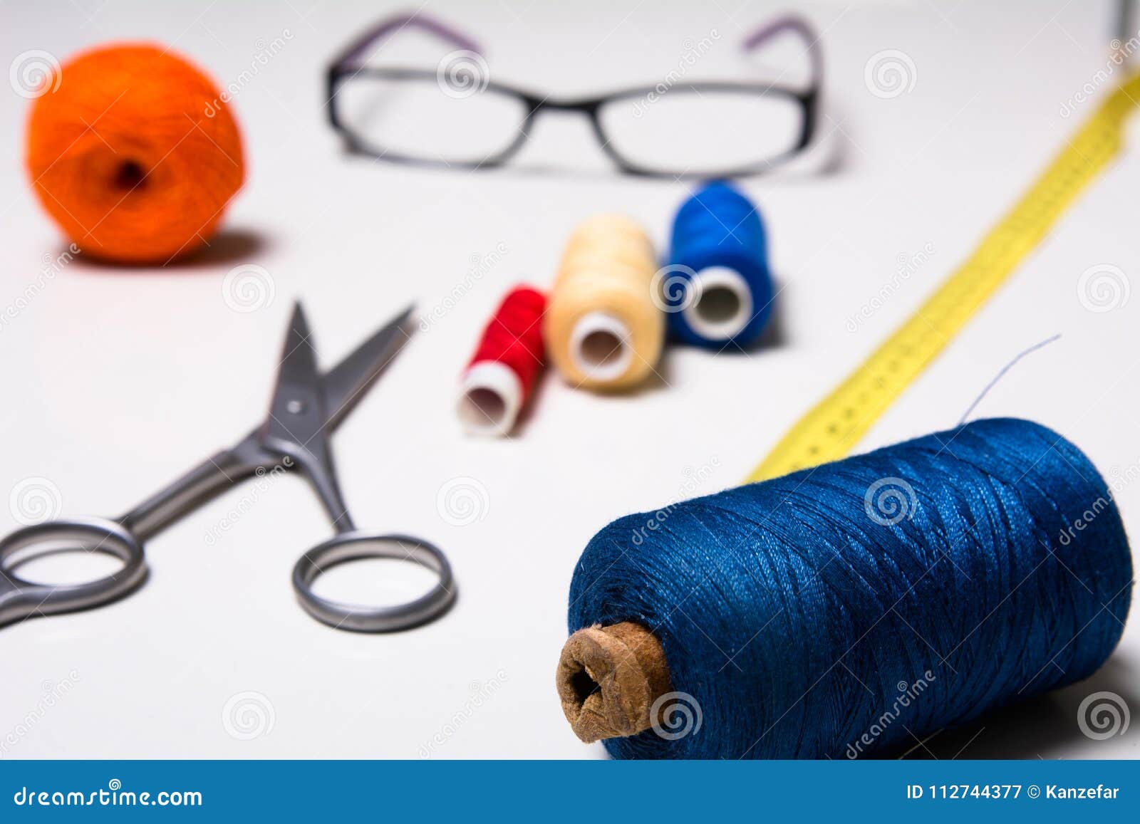 Background of Coil Multicolored Thread, Glasses and Scissors Stock ...