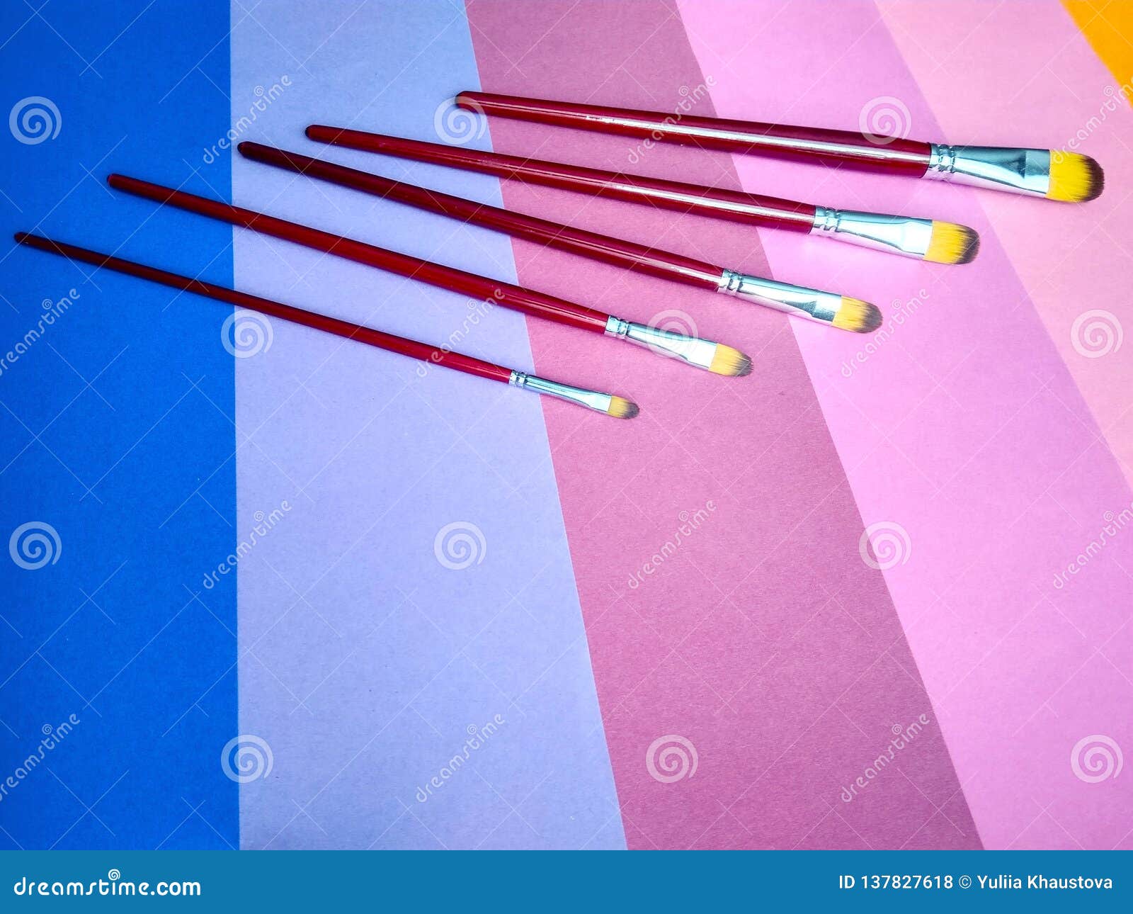 Paint Brushes on a Background of Colored Paper Stock Photo - Image of ...