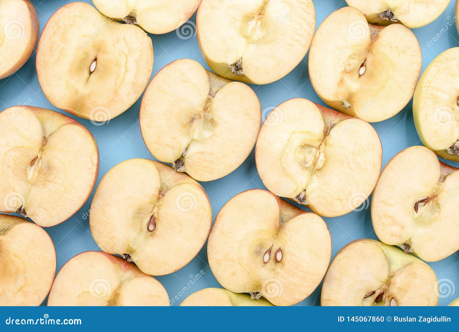 Background of Cut in Half Apples on Blue Background Stock Photo - Image ...