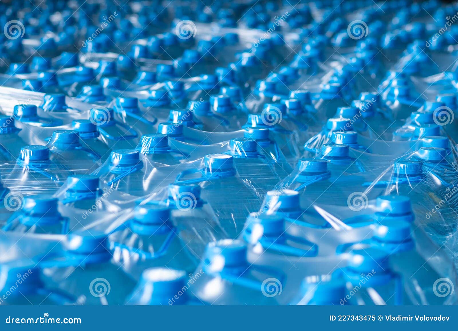Background Image of Blue Plastic Bottles with Blue Caps in Packaging ...