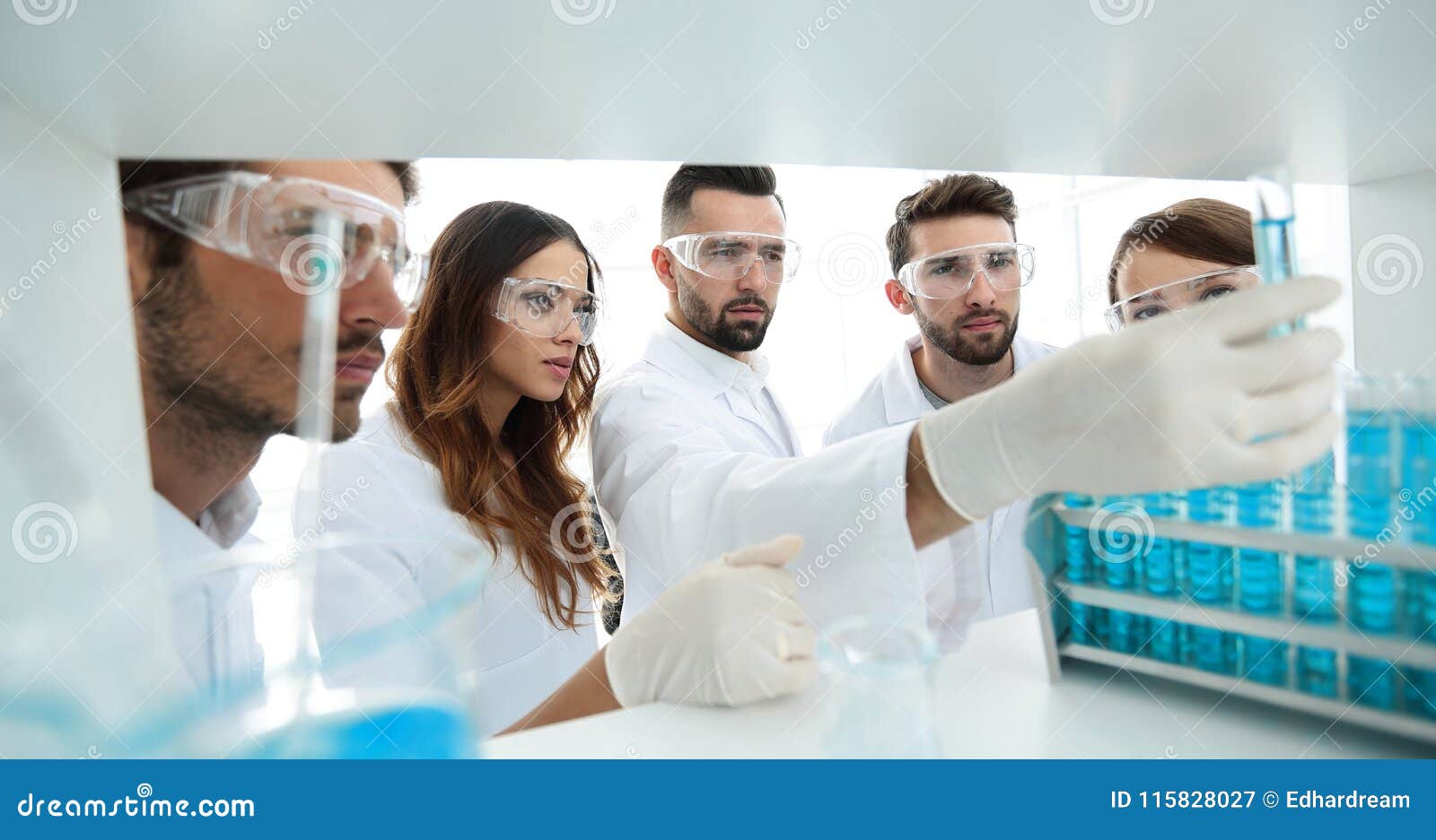 Background Image is a Group of Microbiologists Studying the Liquid in ...