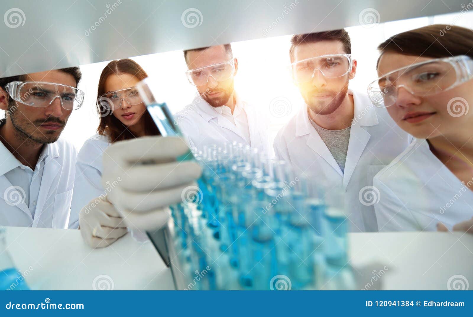 Background Image is a Group of Microbiologists Studying the Liquid in ...