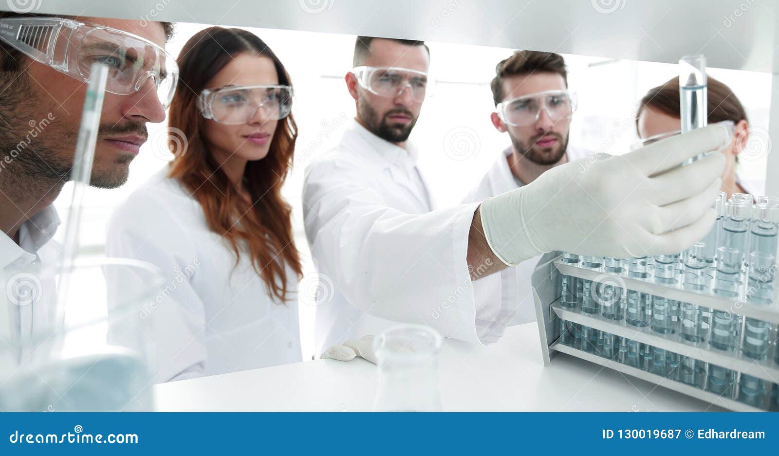 Background Image is a Group of Microbiologists Studying the Liquid in ...