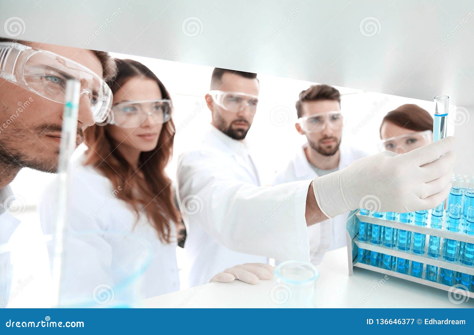 Background Image is a Group of Microbiologists Studying the Liquid in ...