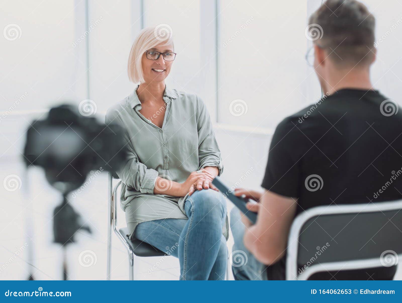 Background Image of a Man and a Woman Sitting in the Studio during the ...