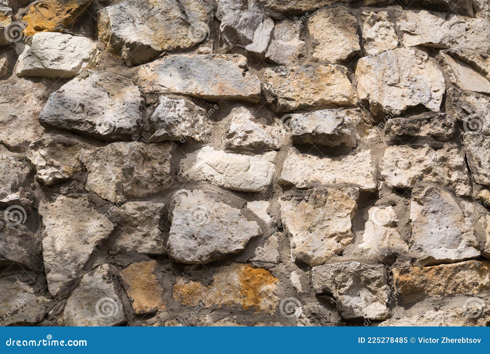 The Background of Irregular Cobblestones is Light Beige and Gray ...