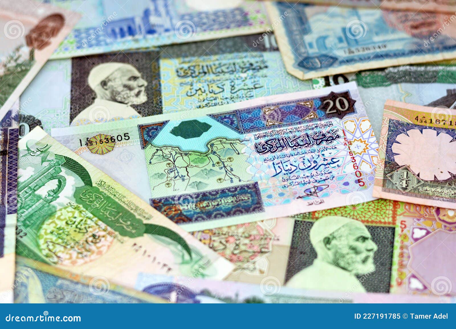 Background of Libyan Money Dinars Banknotes with Portraits of Omar Al ...