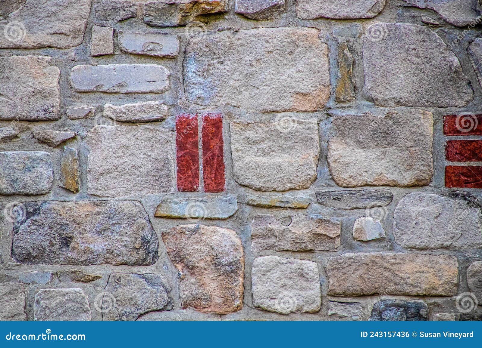 Background of Light Colored Rock Wall with a Few Red Bricks for Accent ...