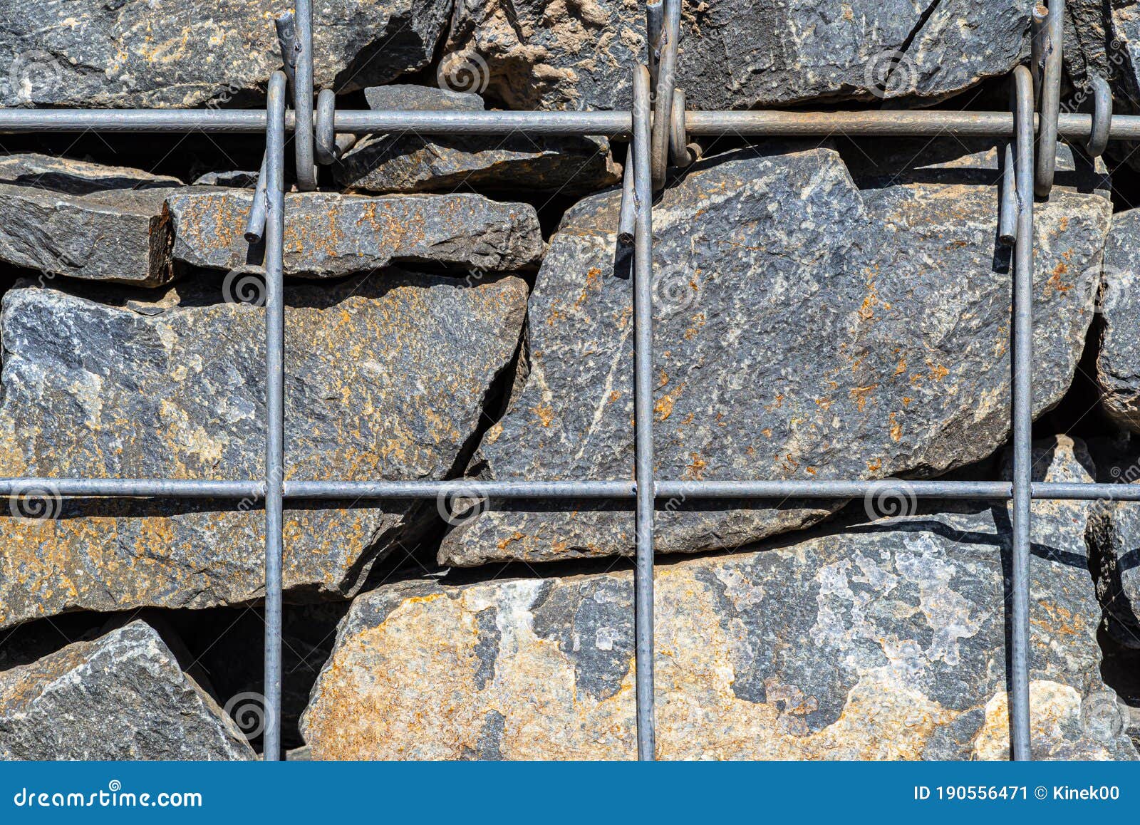 Background Made of a Stone Wall Secured with a Galvanized Metal Mesh ...