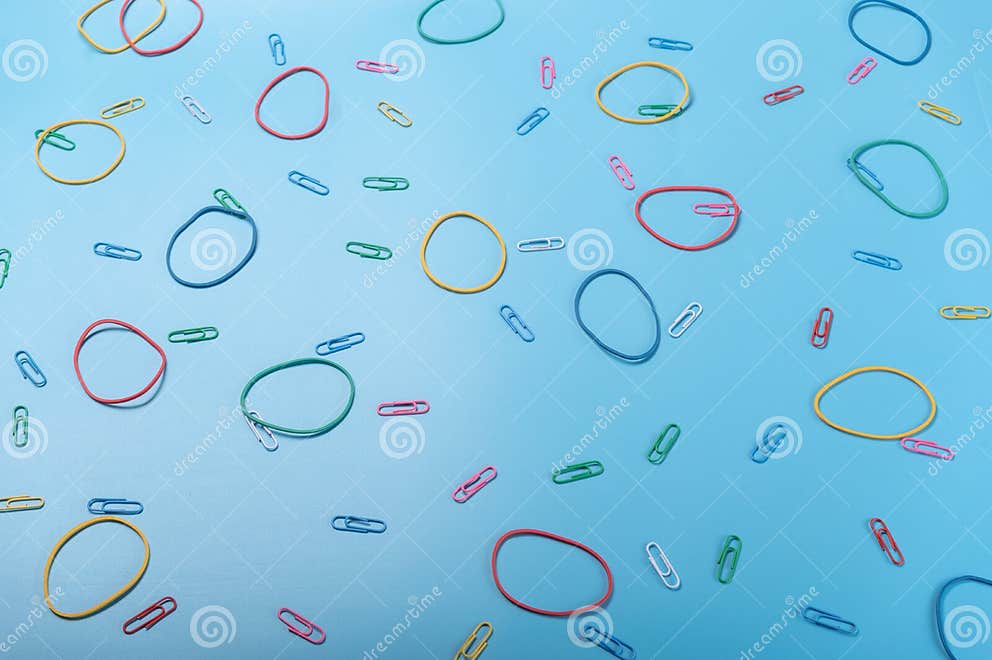 Background from Paper Clips and Rubber Bands. Multi-colored Paper Clips ...