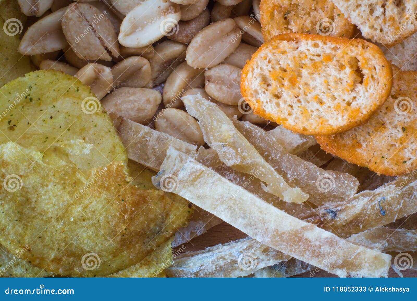 Background of Potato Chips, Fried Peanuts, Slices of Fish and Crackers ...