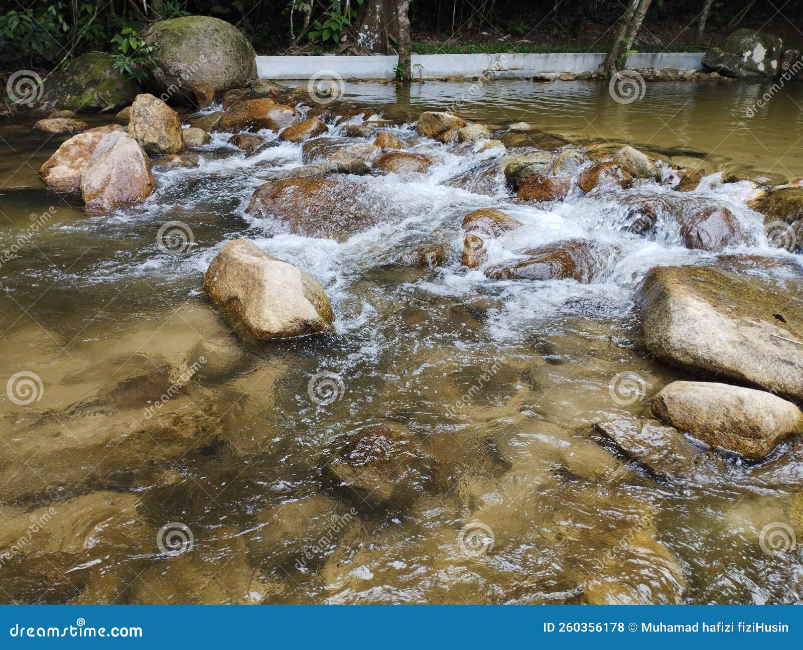 Waterfall With Stone Shrines And Greenery In Bali Countryside ...
