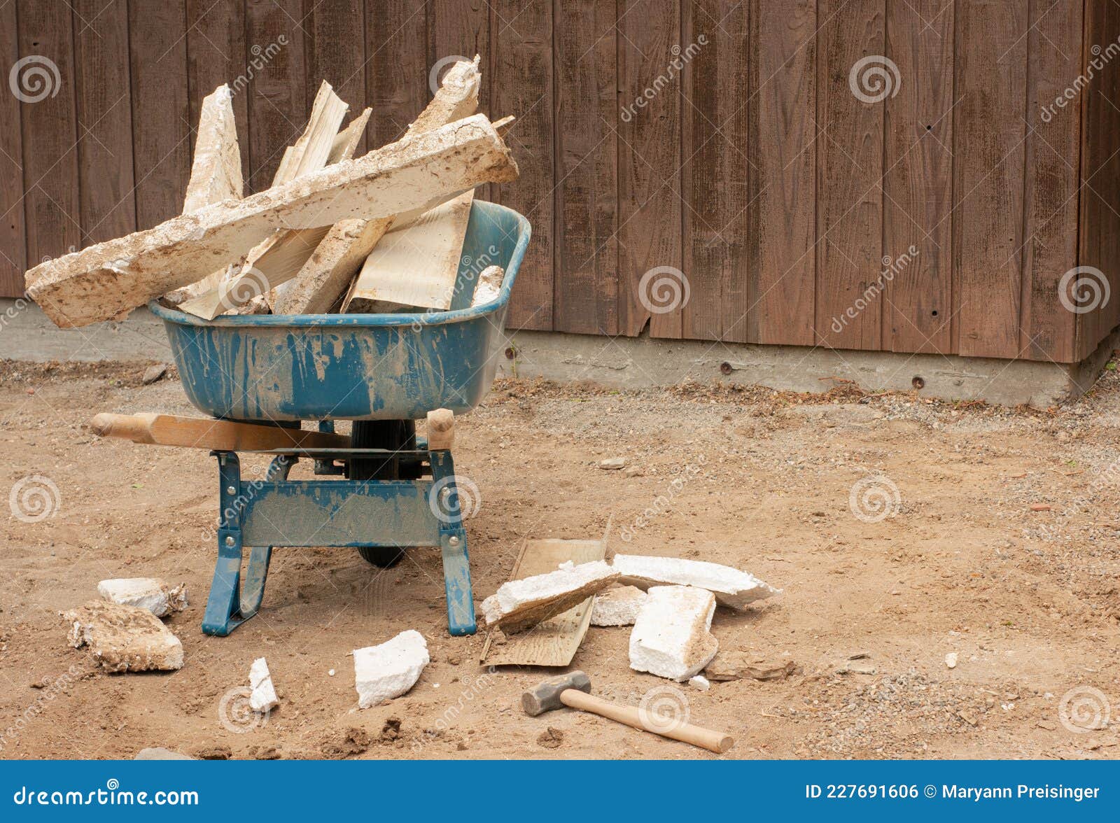 Wheelbarrow Filled with Old Insulation Materials and Cement with ...
