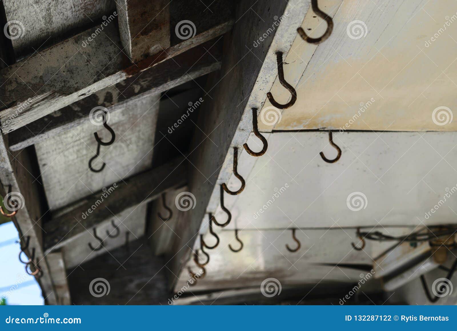 Background Surface of Old and Rusty Hooks Hanging on the Roof Stock ...