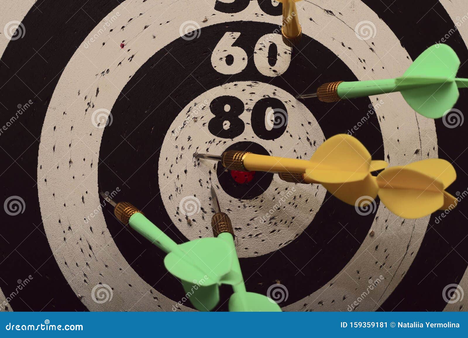 The Background of the Target is Darts with Dart Marks that Hit the ...