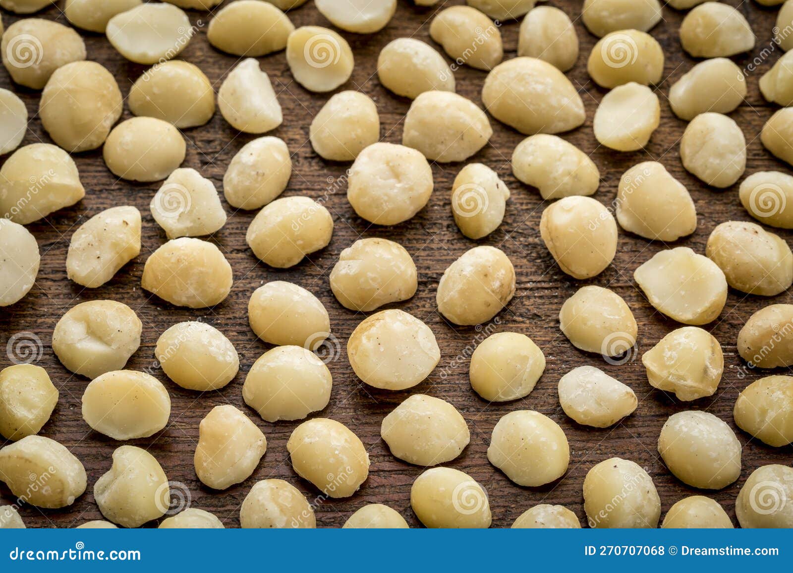 Background Texture of Shelled Macadamia Nuts on Rustic Wood Stock Photo ...