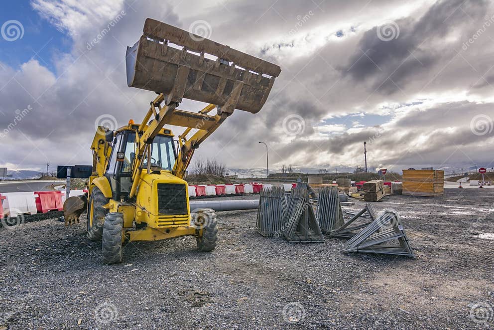 Backhoe on a Construction Site with Material for the Construction of a ...