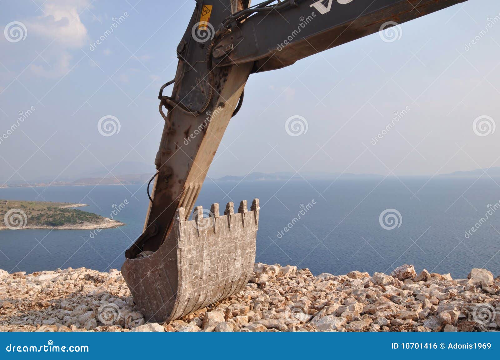 Backhoe digger by ocean stock photo. Image of coast, rocky - 10701416