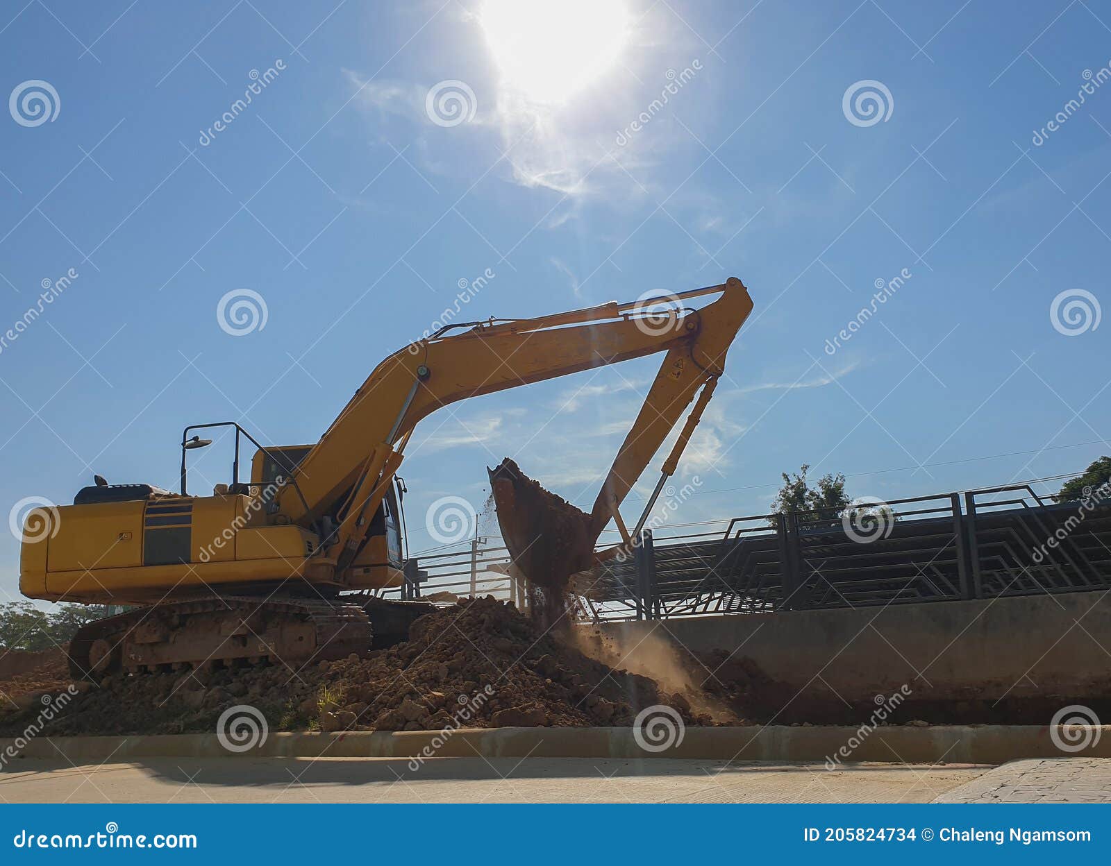 Backhoe Digging in the Factory Under the Sun Stock Photo - Image of ...
