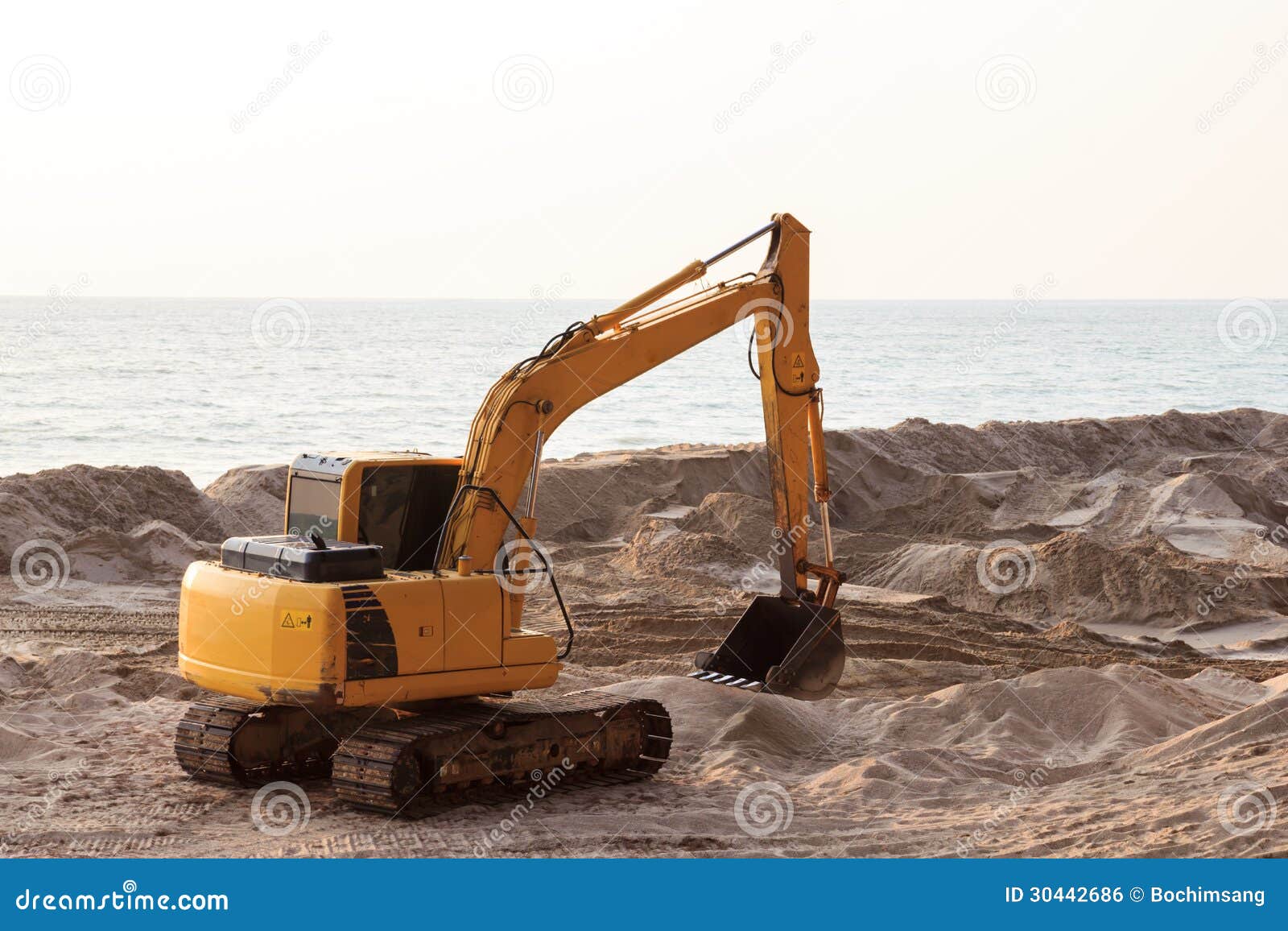 Backhoe Digging in the Sand Stock Photo - Image of surge, disaster ...