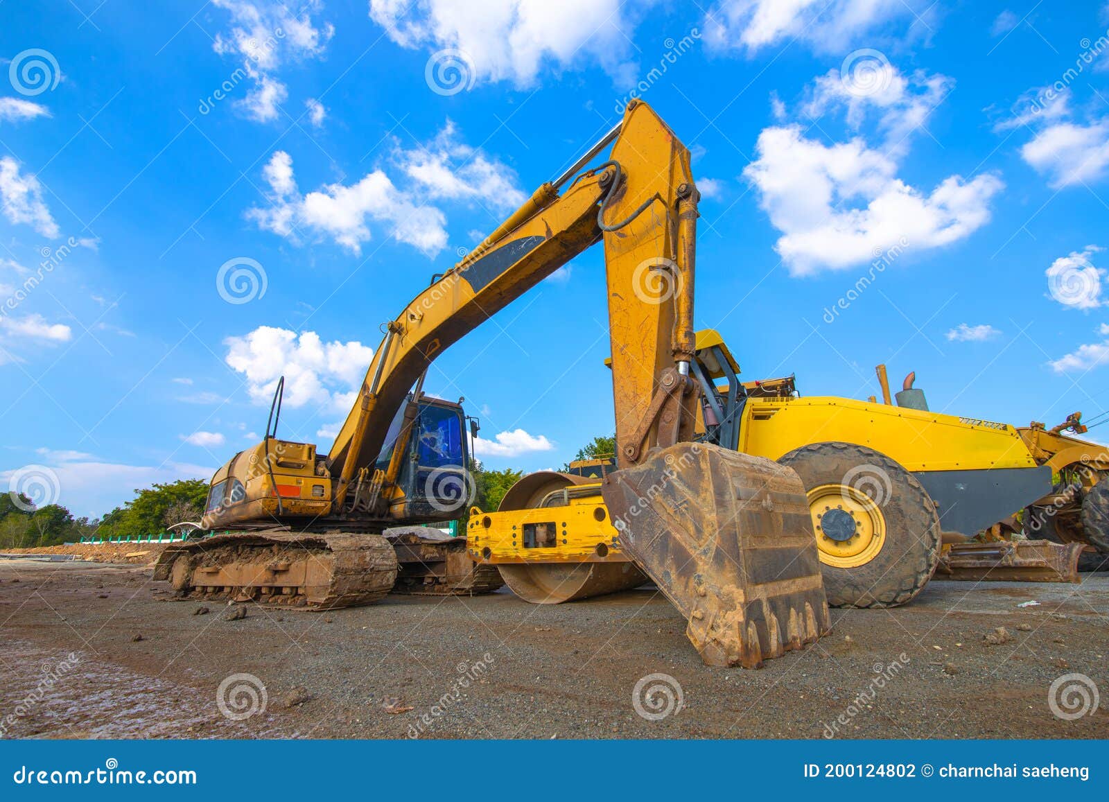 Backhoe, Grader and Road Roller on the Ground at Site Construction ...