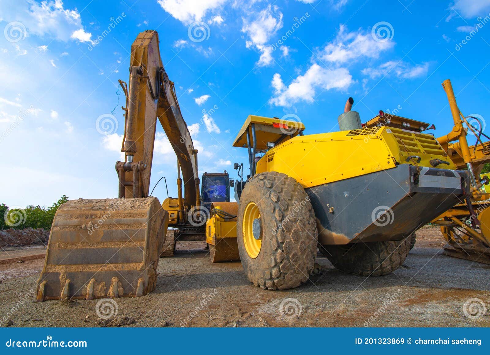 Backhoe, Grader and Road Roller on the Ground at Site Construction ...