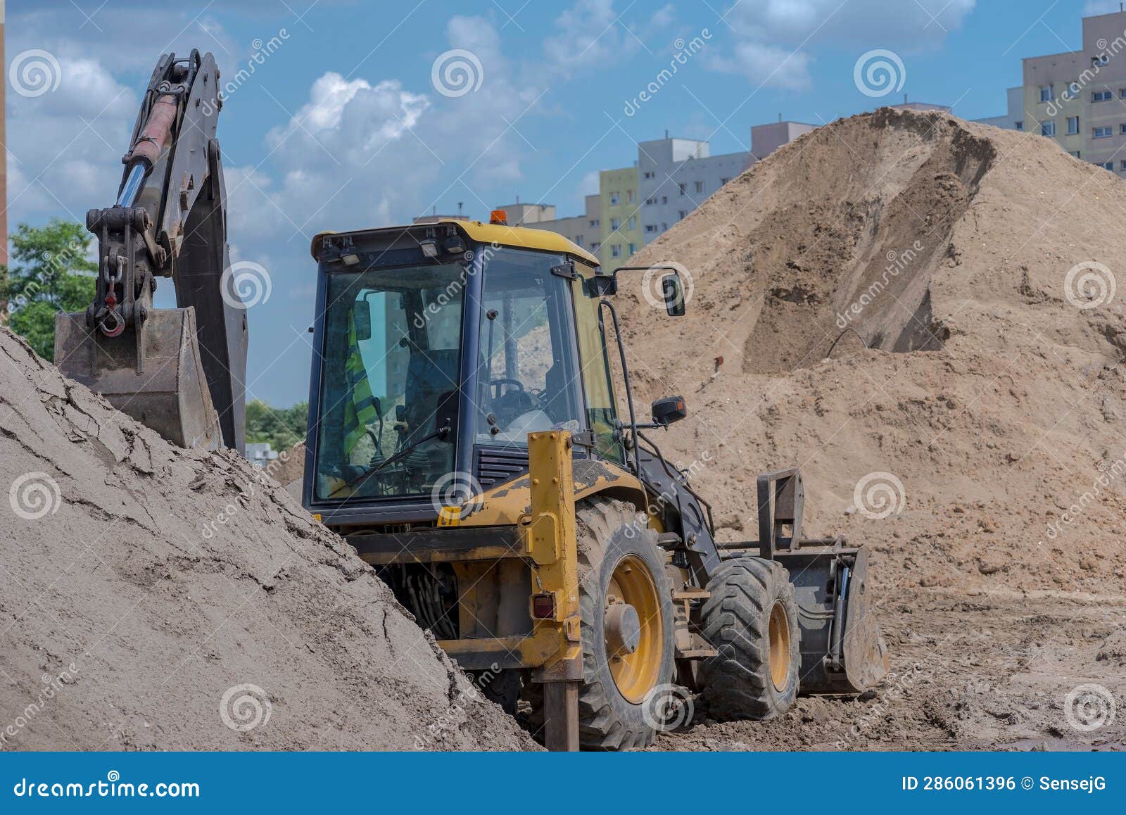 Backhoe Loader at a Construction Site among the "mountains". Stock ...