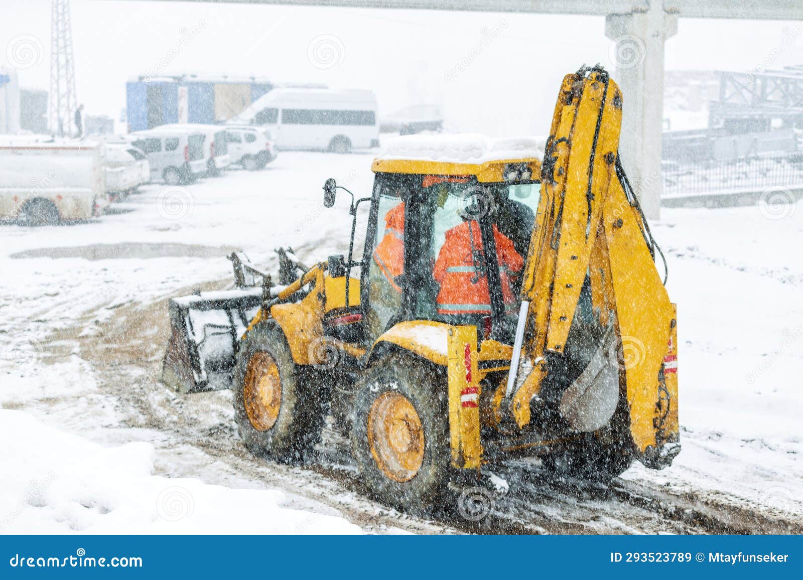 Backhoe Loader and Snowy Day in the Construction Site. it Also Called a ...
