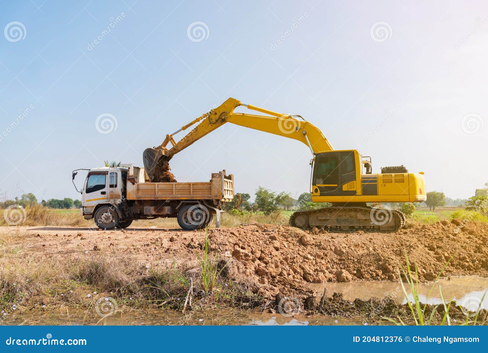 Backhoe Loader Soil From The Ground Up To Dump Truck Stock Photo ...