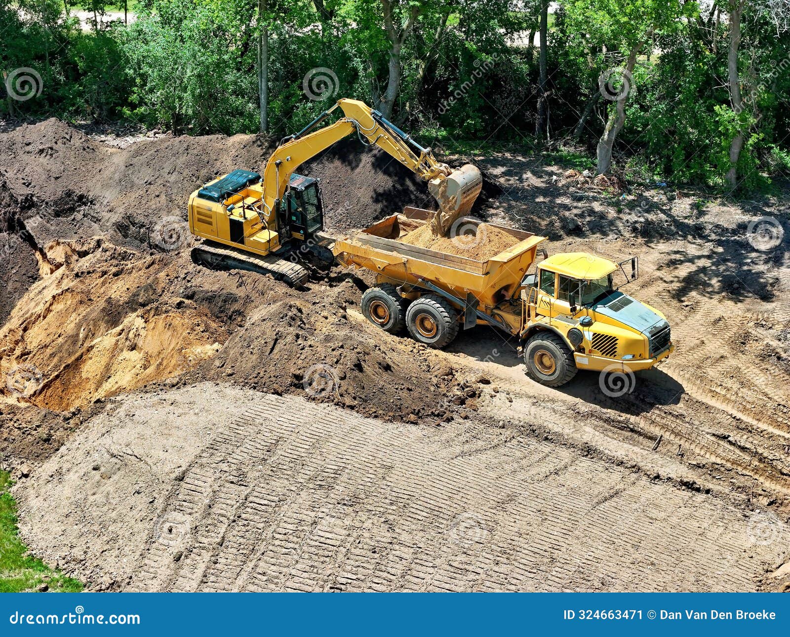 Backhoe Loading a Large Dump Truck at a Construction Site Stock Image ...