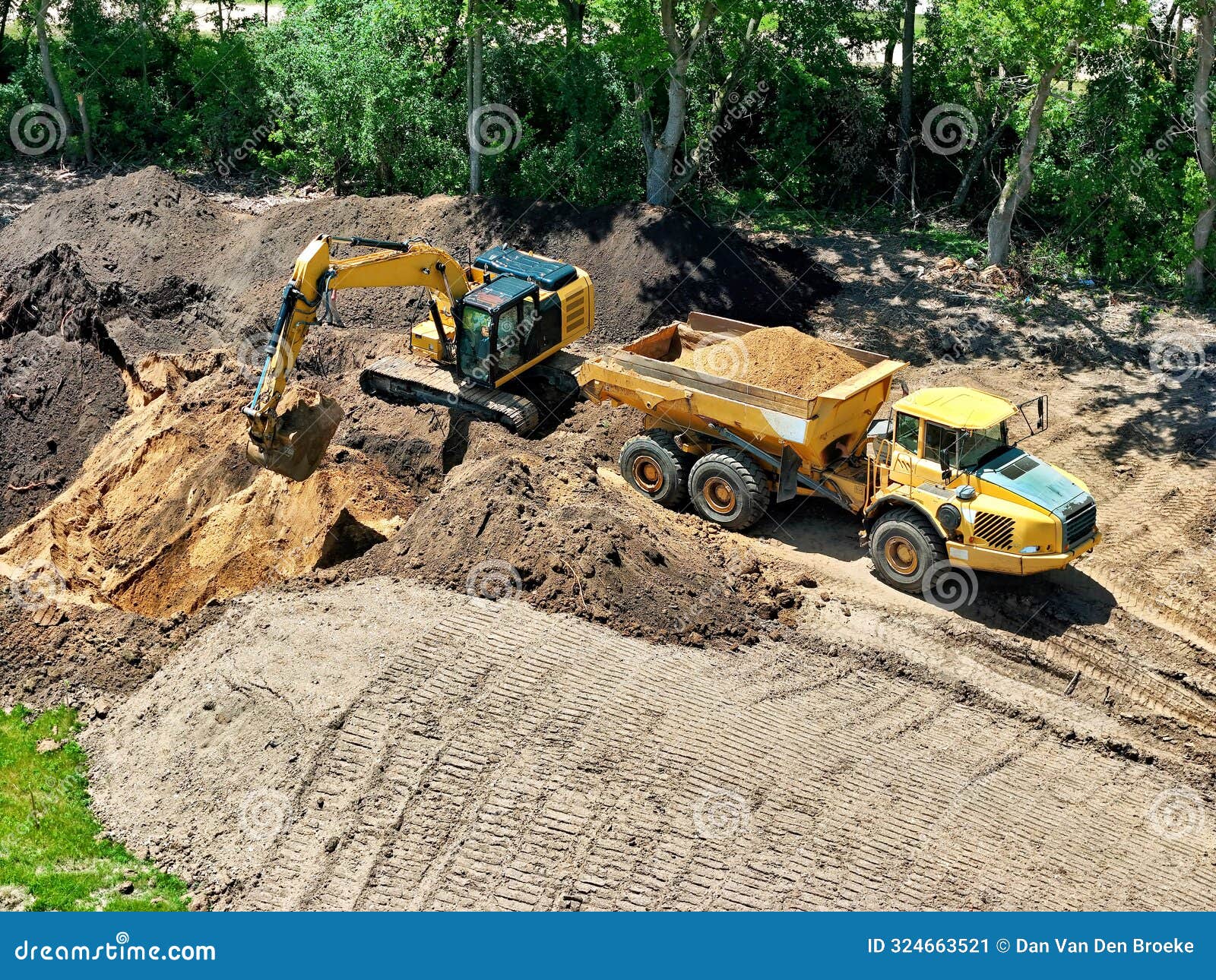 Backhoe Loading a Large Dump Truck at a Construction Site Stock Image ...