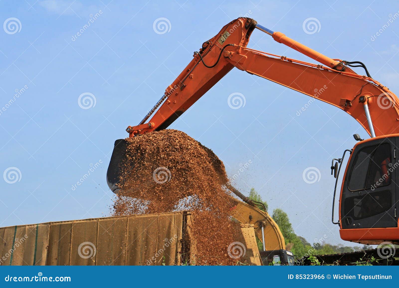 Backhoe Loading Woodchip into Truck Stock Photo - Image of actor ...