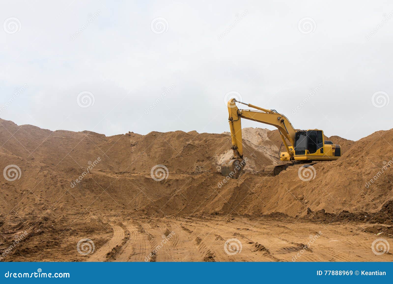 Backhoe on the sand track. stock image. Image of digger - 77888969