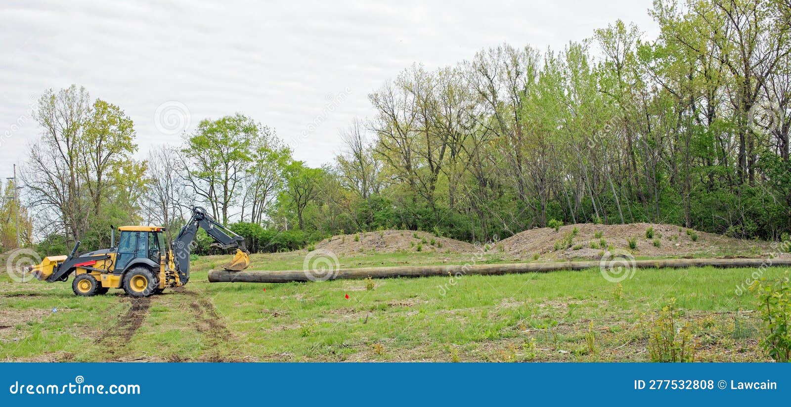 Backhoe Ready To Pull 80 Foot Utility Pole into Place Stock Photo ...
