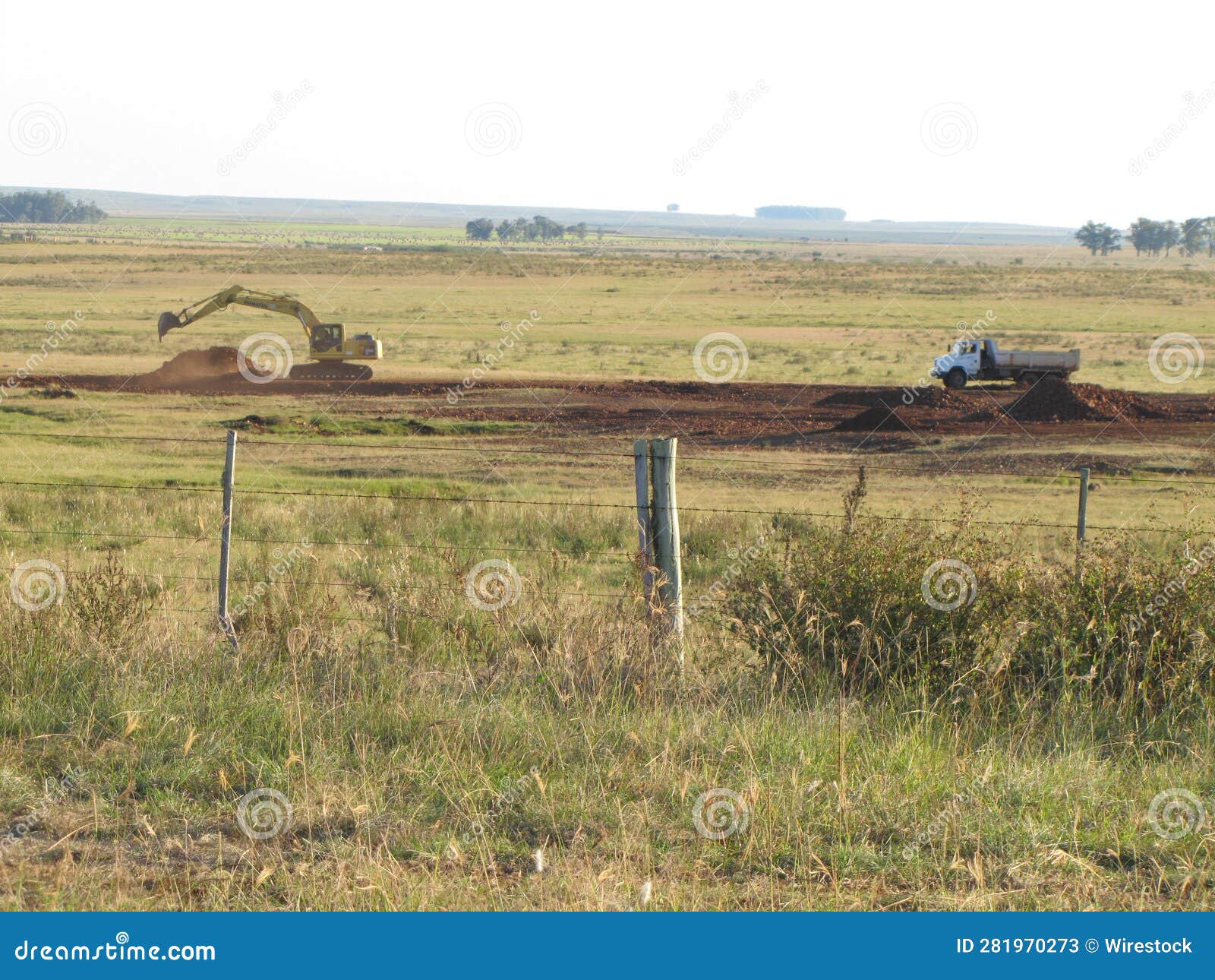 Backhoe and Truck on the Field Digging the Ground Stock Image - Image ...