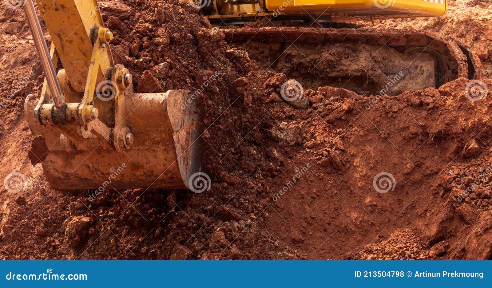 Backhoe Working by Digging Soil at Construction Site. Bucket of Backhoe ...