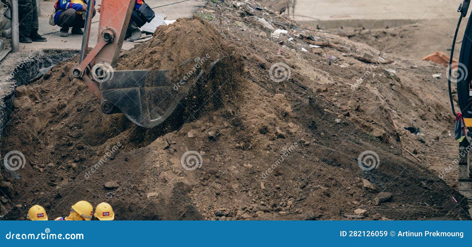 Backhoe Working By Digging Soil At Construction Site. Bucket Of Backhoe ...