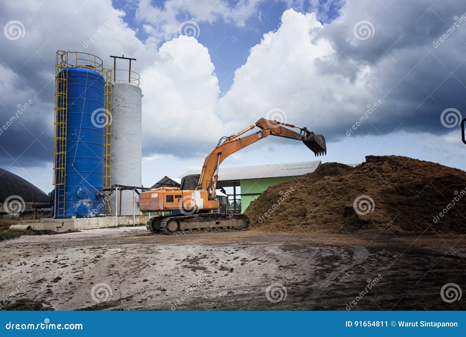 Backhoe Working By Digging Soil At Construction Site And Loading To The ...