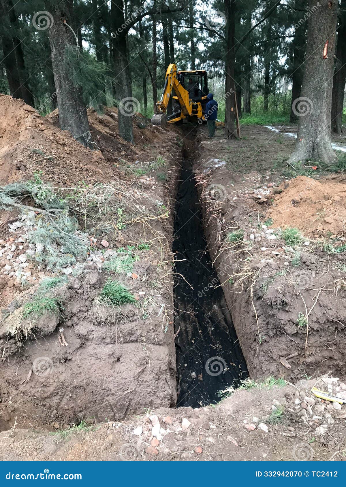Backhoe Working By Digging Soil At Construction Site And Loading To The ...