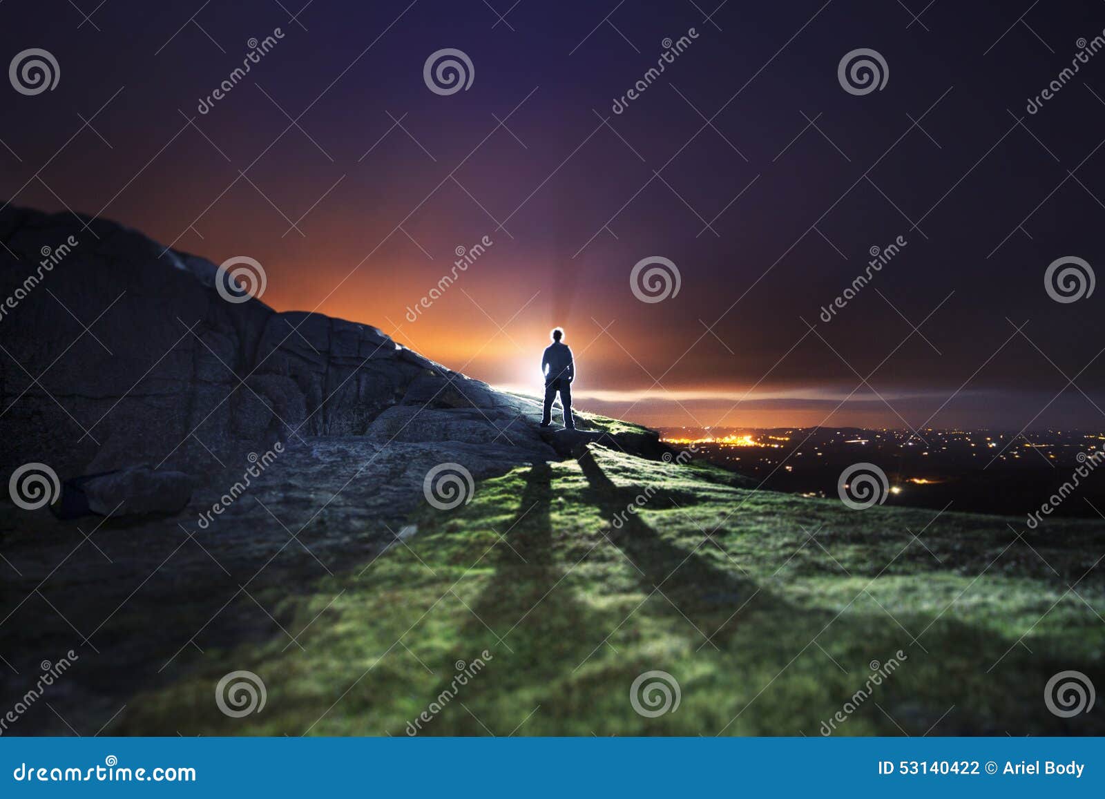 Backlit Man on Mountaintop Over City Stock Photo - Image of eerie ...