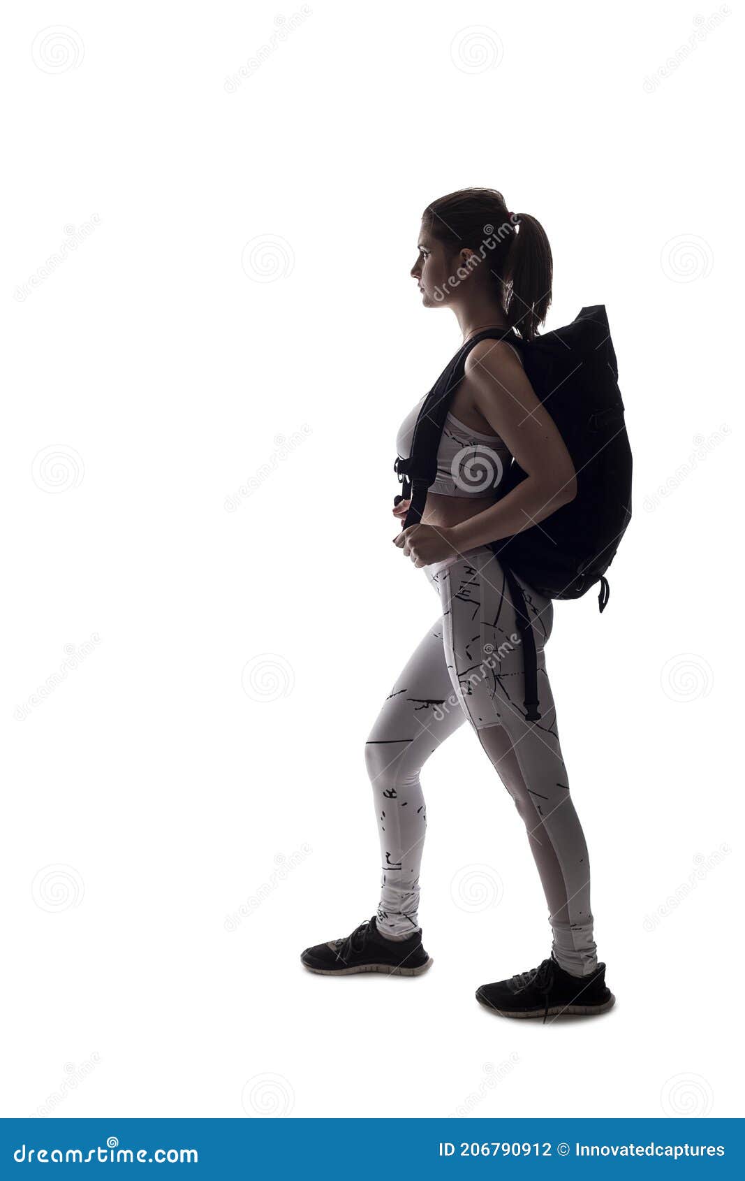 Backlit Model Posing As a Hiker or Backpacker on a White Background for ...
