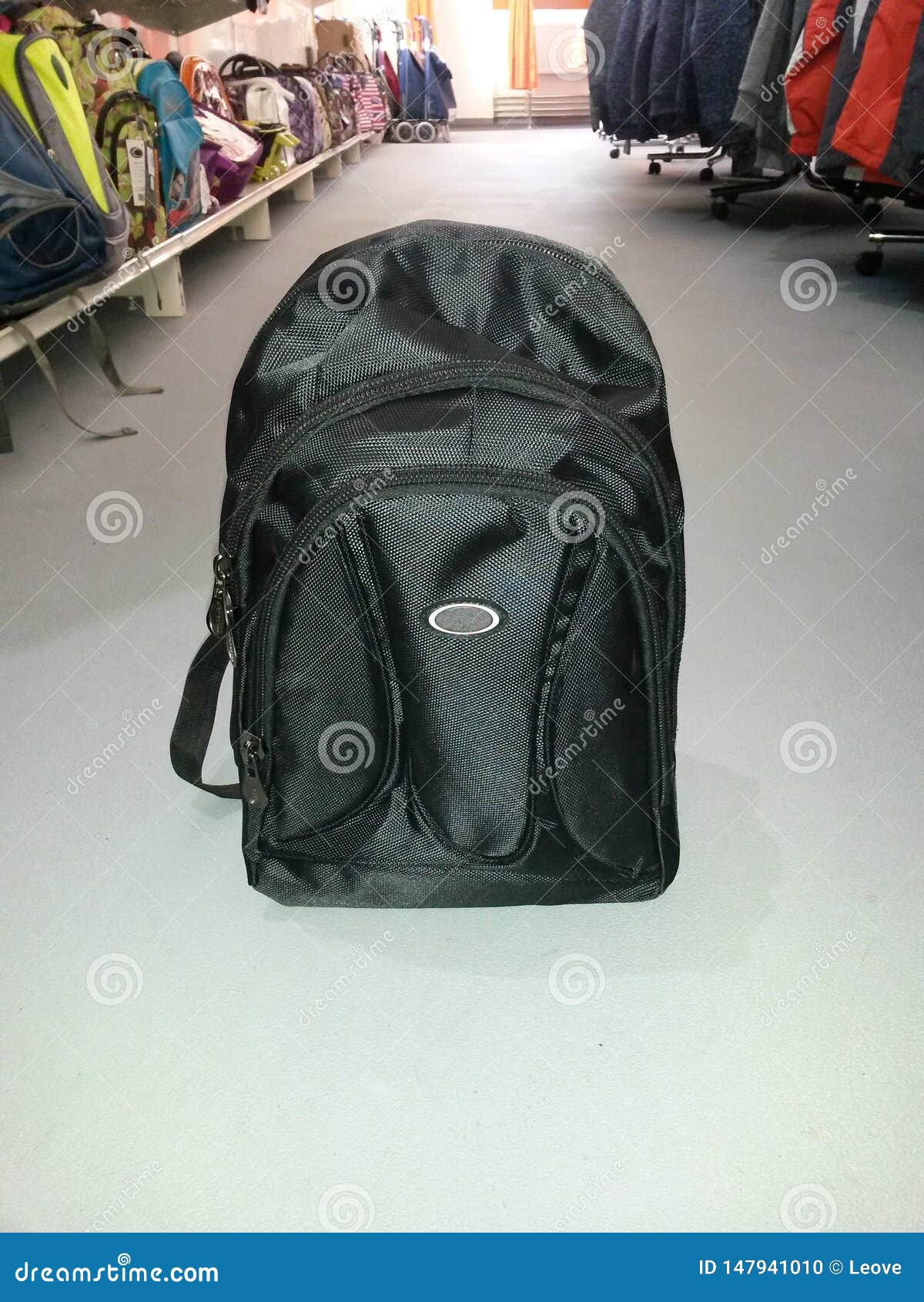 Backpack Black on the Ground in Backpacks and Clothes Store Stock Photo ...