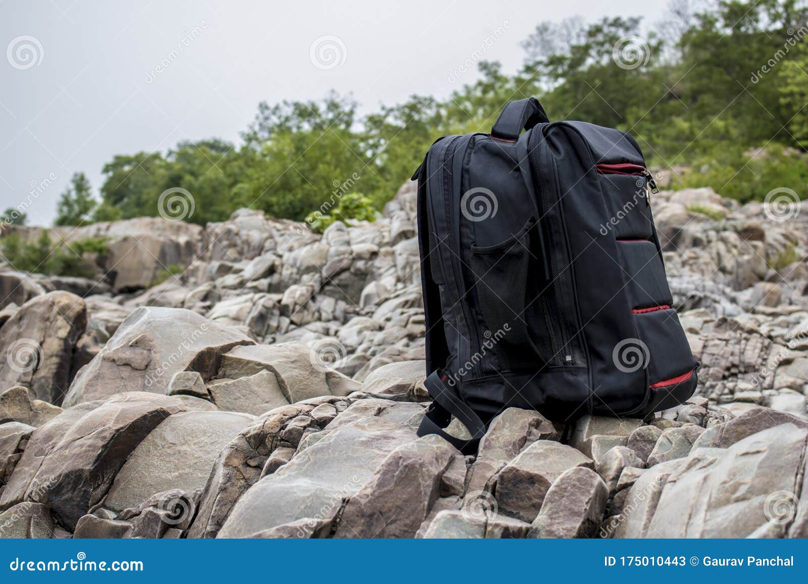A backpack on the rocks stock image. Image of green - 175010443