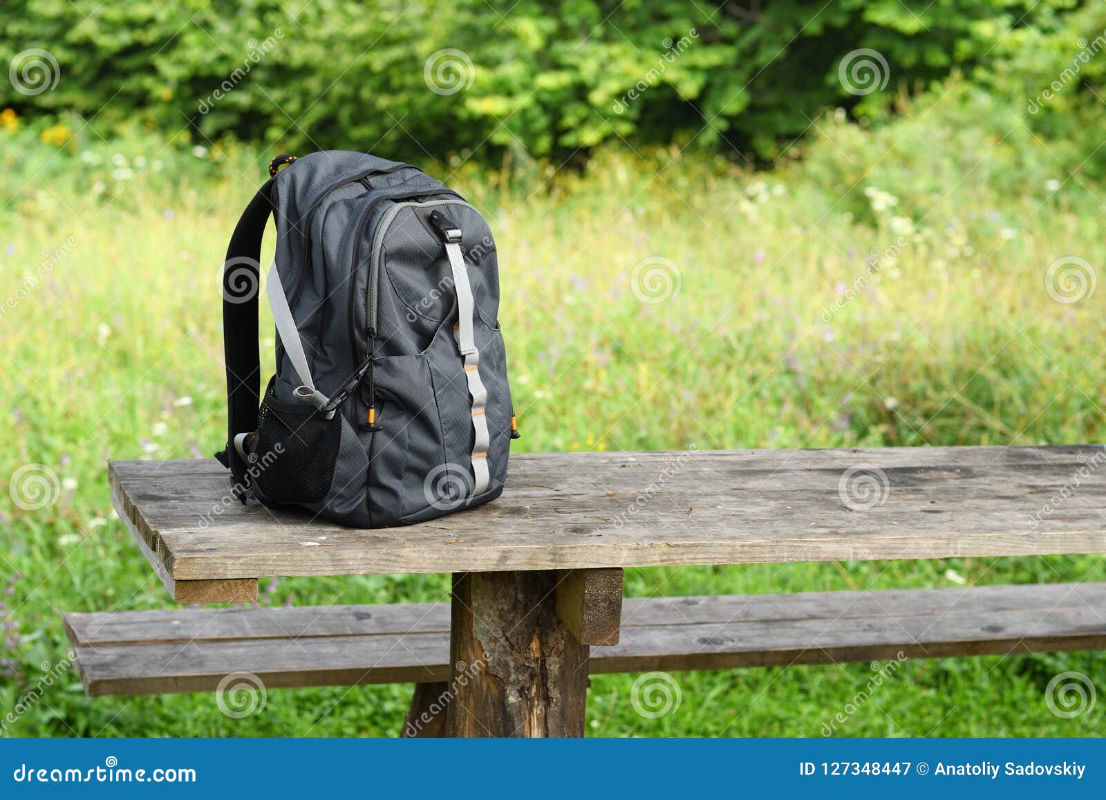 Backpack on wooden table stock image. Image of green - 127348447