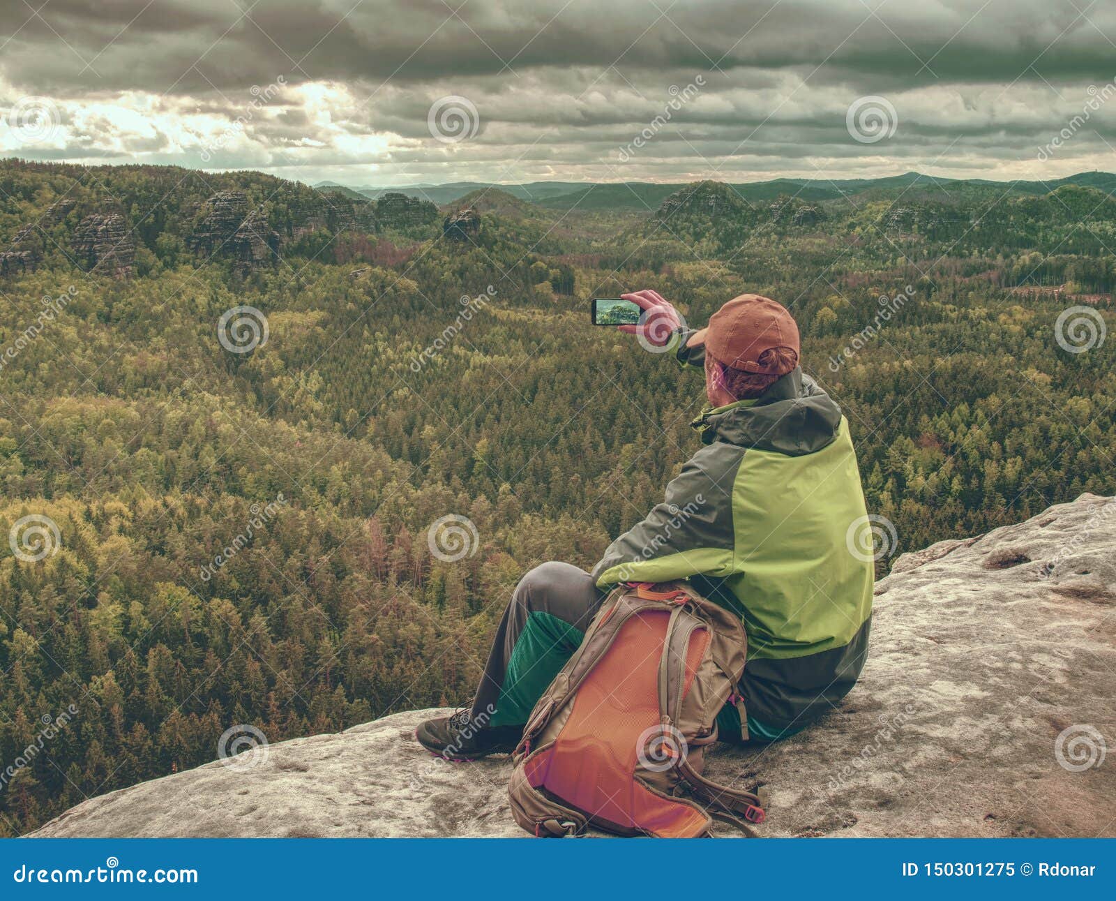 Backpacker with Phone in Hand. Spring Valley in Rocky Mountains Stock ...