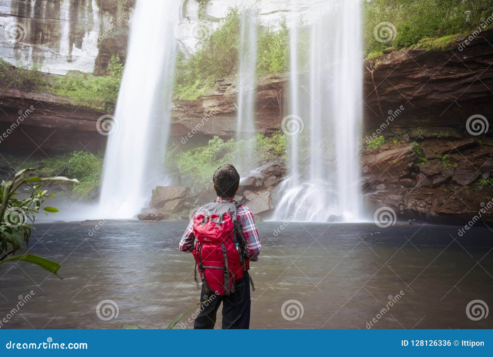 Backpacker Standing in Front of Waterfall Stock Photo - Image of ...