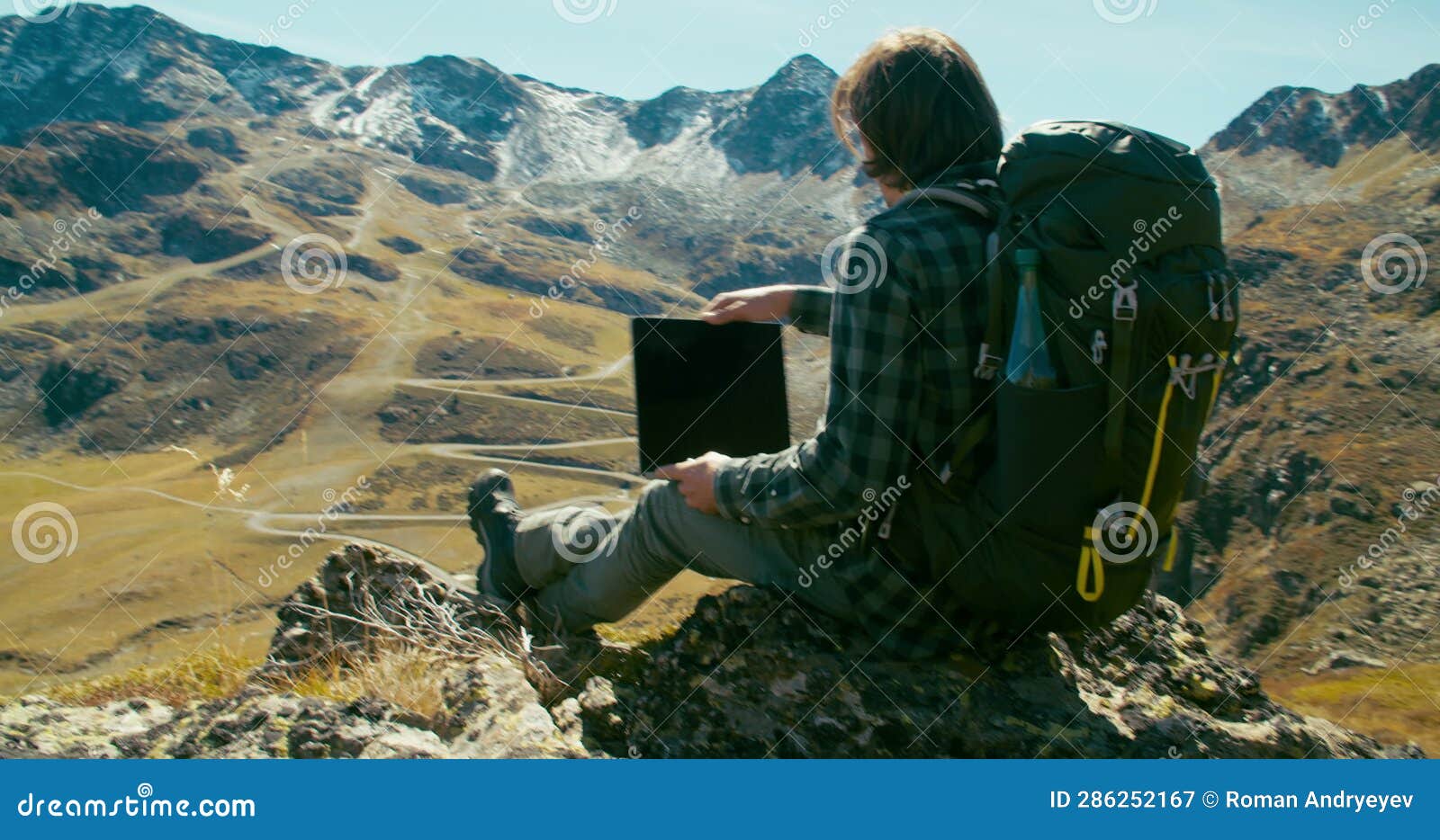 Backpacker Walk and Sit on Rock with Epic Mountain View and Open Laptop ...